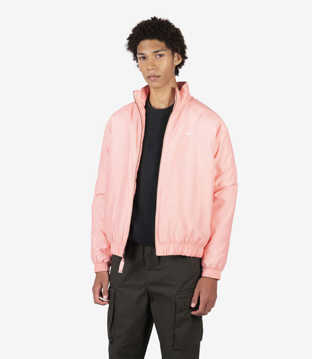 Shop NikeLab Solo Swoosh Satin Bomber Jacket Bleached Coral/White at ...